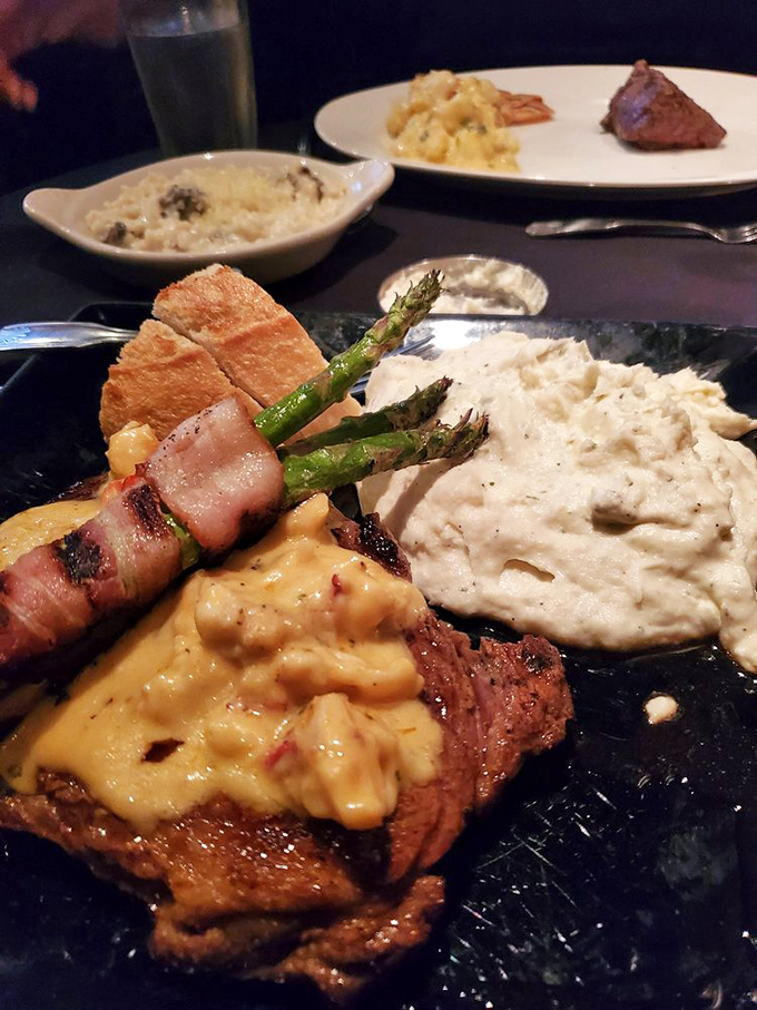 Steak topped with melted cheese, bacon-wrapped asparagus, and cloud-like mashed potatoes &ndash; the holy trinity of steakhouse perfection.