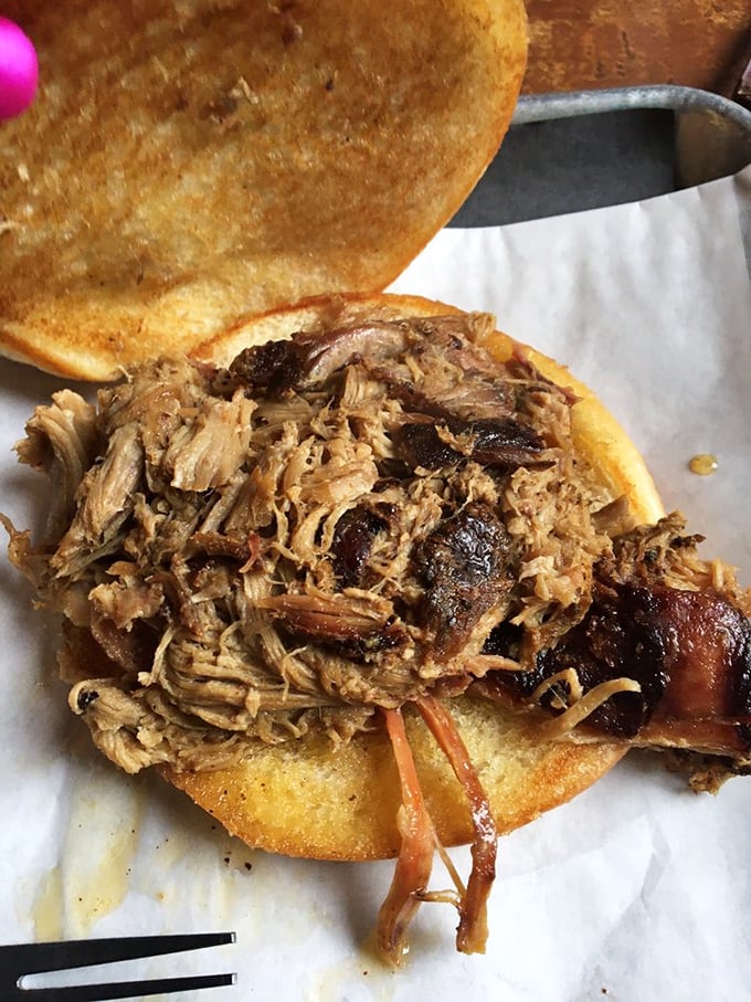 This pulled pork sandwich isn't just food&mdash;it's architecture. Notice how the bark-studded meat creates a perfect balance of texture and flavor.