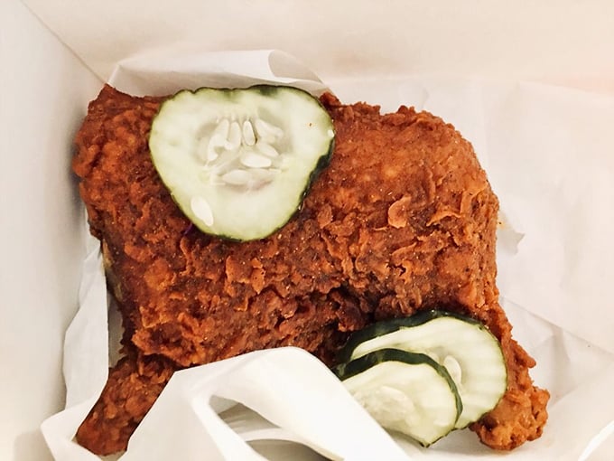 This quarter bird with its russet crust and pickle garnish isn't just chicken&mdash;it's edible architecture. The kind of crispy exterior that makes a sound your neighbors can hear.