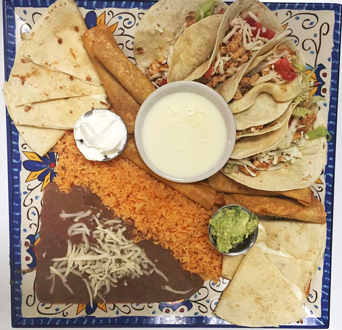 This colorful fiesta of a plate proves that indecision can be delicious—tacos, quesadillas, and flautas share space with perfectly prepared rice and beans.