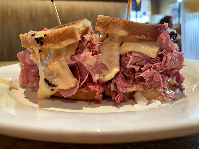 The legendary Reuben in all its glory. That melty cheese cascading over perfectly stacked corned beef is what sandwich dreams are made of.