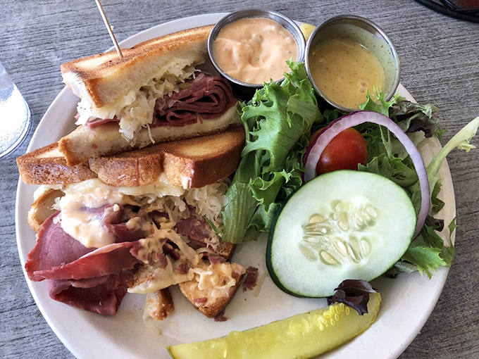 The legendary Reuben in its natural habitat&mdash;tender corned beef, tangy sauerkraut, and melted Swiss on grilled rye, with a fresh side salad playing backup.