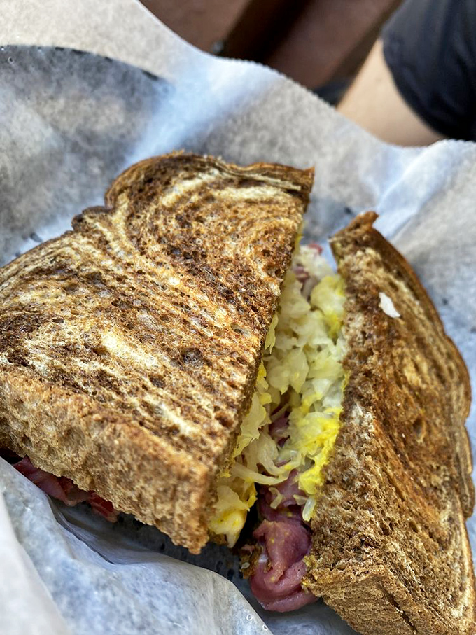 This isn't just a sandwich; it's a masterclass in balance. The perfectly grilled rye cradles that heavenly combination of corned beef and sauerkraut.