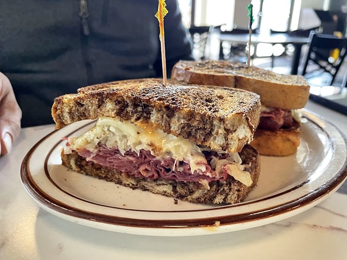 Holy moly, would you look at that Reuben! It's stacked higher than a New Yorker's ambitions and oozing more charm than a Midwest grandma at a potluck.