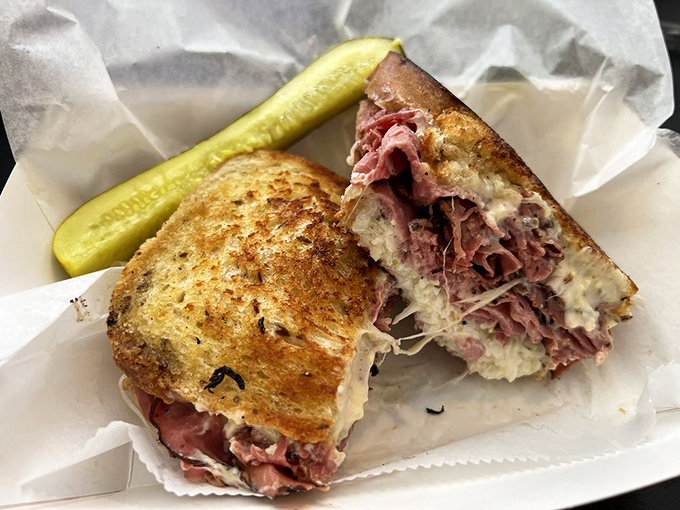 A proper Reuben doesn't whisper, it announces itself. This beauty, with its cascade of corned beef and melted Swiss, speaks volumes.