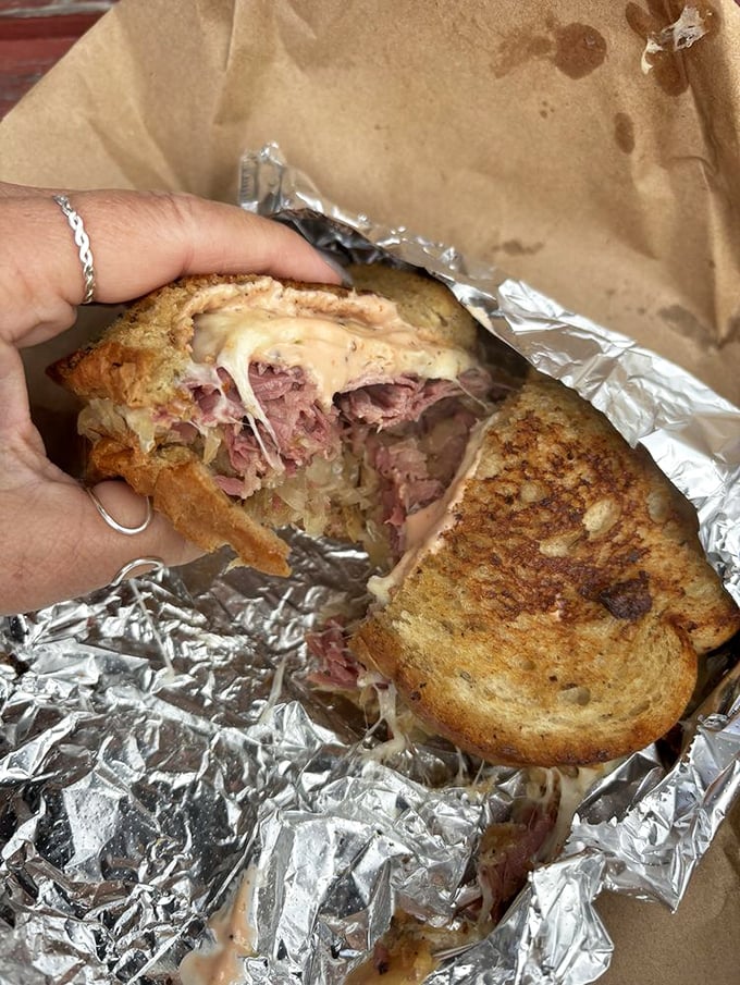 This Reuben isn't just a sandwich, it's an architectural masterpiece of flavor. That cheese pull belongs in the Louvre &ndash; if the Louvre celebrated deliciousness.