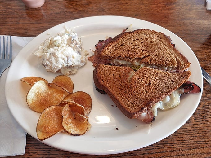 The Reuben arrives like a work of art&mdash;toasty rye, melty Swiss, and that perfect pile of corned beef, with potato salad standing by for moral support.