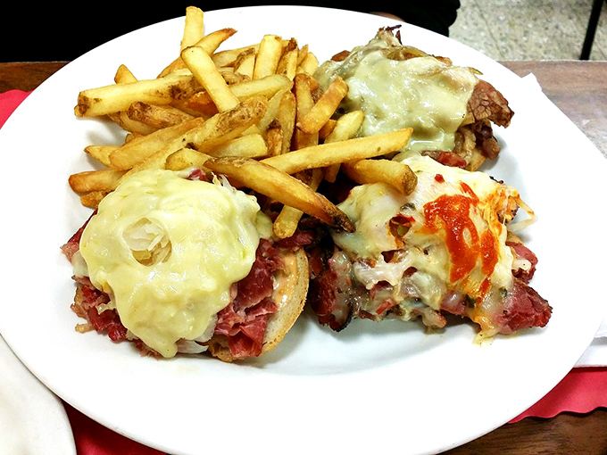 Behold the Reuben in its natural habitat&mdash;melted Swiss cascading over corned beef with fries standing guard. This isn't lunch, it's a celebration.