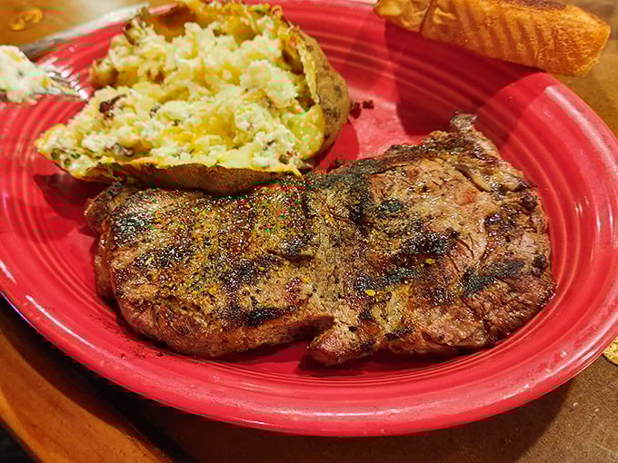This isn't just a steak; it's a declaration of love to beef enthusiasts. The perfect sear, the loaded baked potato&mdash;romance on a red plate.