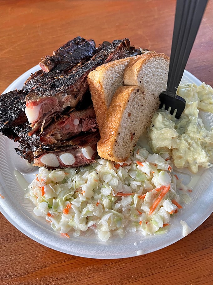 Ribs with that perfect smoke ring nestled against creamy coleslaw&mdash;a plate that makes you want to cancel all afternoon appointments.