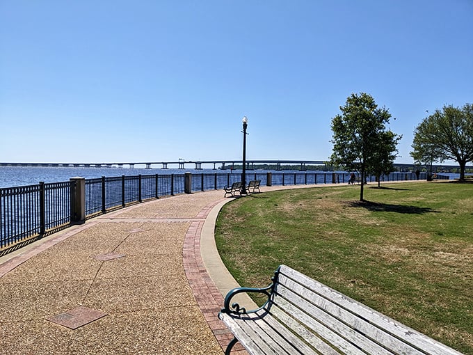 The Riverwalk offers contemplative benches perfectly positioned for both sunset viewing and quietly judging the yachting abilities of complete strangers.