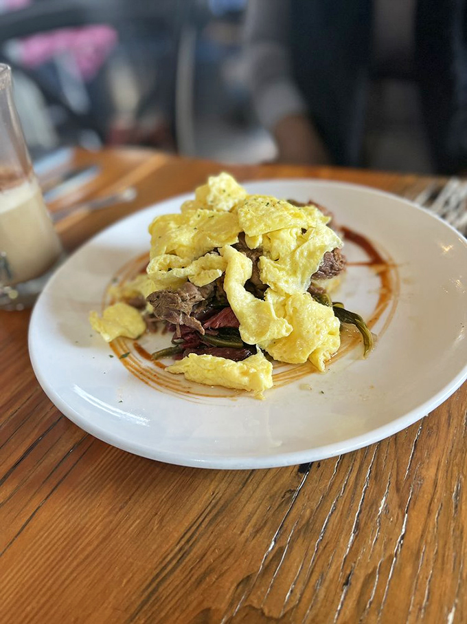 Scrambled eggs lounging atop slow-roasted beef like they're on vacation. This plate doesn't just break your fast&mdash;it makes your whole morning.