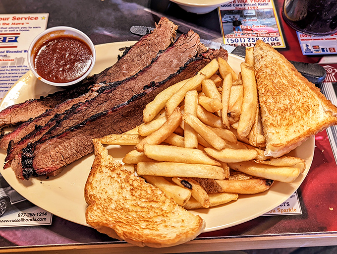 Behold the brisket in all its glory&mdash;tender slices with that perfect smoke ring, flanked by golden fries and toast. A holy trinity of comfort.