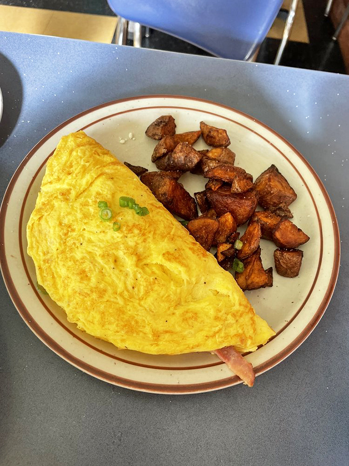 Simplicity perfected: a golden omelet with crispy home fries that prove sometimes the classics don't need reinventing, just respect.