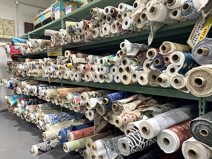 Roll after glorious roll, stacked like the world's most colorful library. Each one contains a story waiting to be stitched.