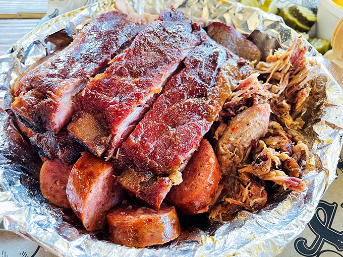 Meat Tetris at its finest&mdash;ribs, sausage, and pulled pork arranged in a symphony of smoke that would make Mozart weep.