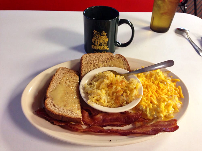 Breakfast of champions! Crispy bacon, buttery toast, and scrambled eggs that actually taste like eggs should. The coffee mug says it all.