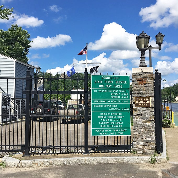 Sunlight glistens on the river as you prepare to cross the water on a historic ferry during a clear day.