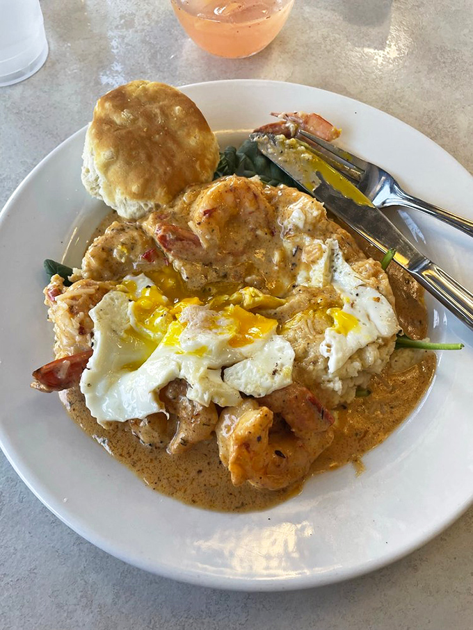 Shrimp and grits that make you question all your life choices—why haven't you been eating this every day? The sunny-side egg on top is like the universe winking at you.