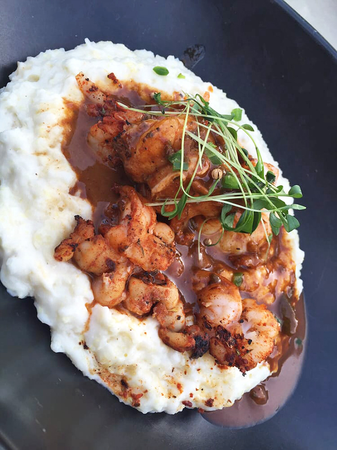Behold the dish that launches road trips! Blackened shrimp nestled on creamy grits with that jalape&ntilde;o avocado gravy&mdash;comfort food that got a graduate degree.