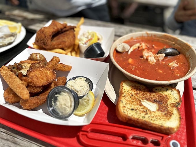 Seafood nirvana on a tray: golden fried morsels alongside a tomato-based cioppino that would make a mermaid weep with joy.