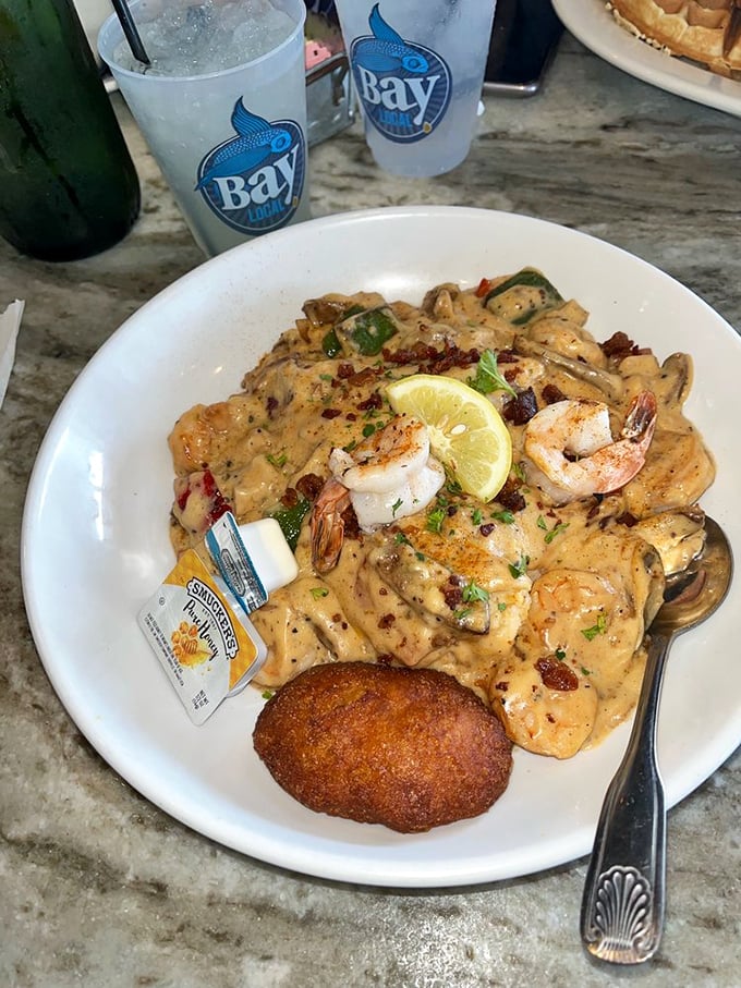 Behold the star attraction! This isn't just shrimp and grits &ndash; it's a creamy, savory masterpiece garnished with plump shrimp and a symphony of flavors.