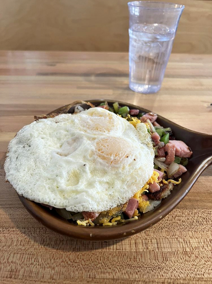 A skillet that means business: perfectly cooked eggs crowning a mountain of savory ingredients. This isn't breakfast&mdash;it's an edible adventure.