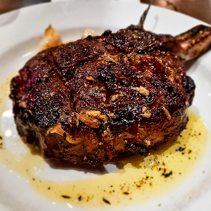 The bone-in ribeye glistens with juices that would make even vegetarians question their life choices. That crust deserves its own ZIP code.