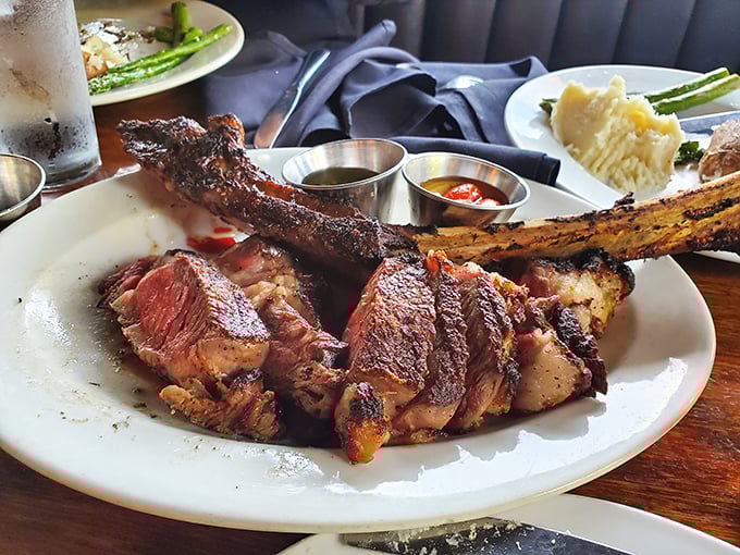This isn't just meat; it's a masterpiece. The tomahawk ribeye arrives like a prehistoric indulgence, perfectly charred outside, blushing within.