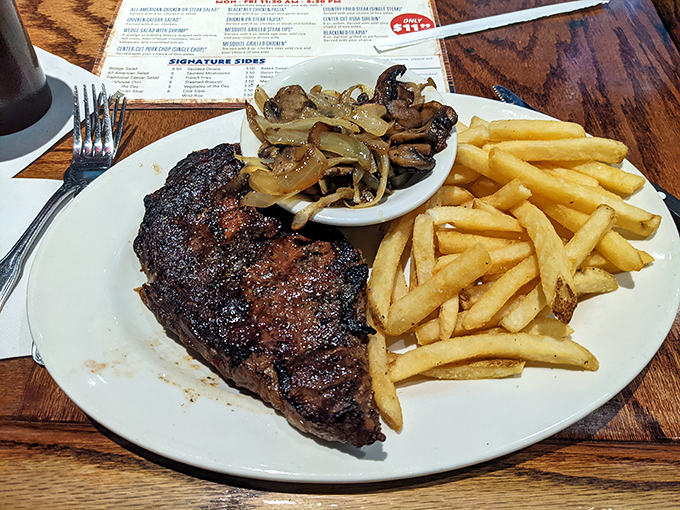 Behold, the star of the show&mdash;a perfectly seared steak with that textbook crust, flanked by golden fries and saut&eacute;ed mushrooms. Meat poetry on a plate.