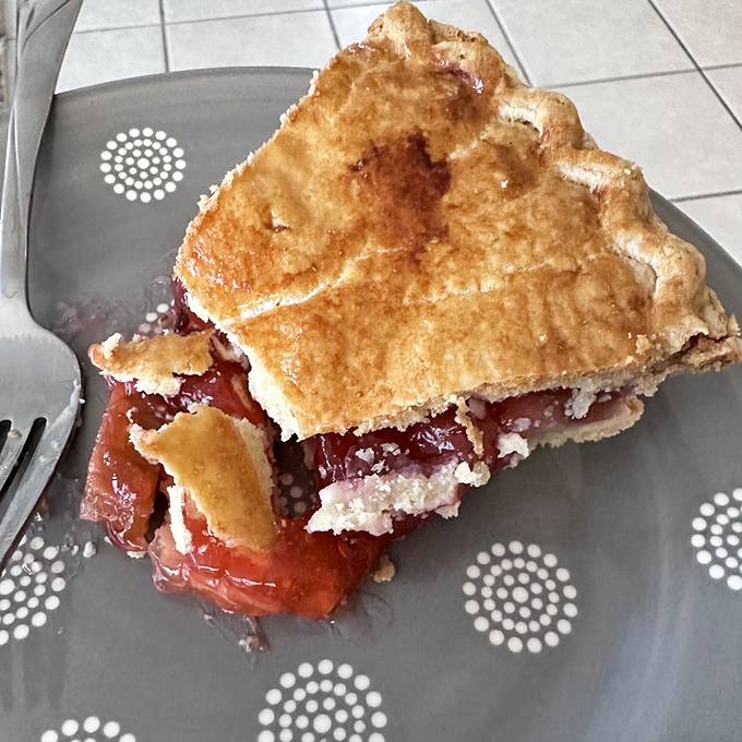 The star of the show: strawberry rhubarb pie with its perfect sweet-tart balance. That crimson filling peeking through golden crust is nature's most perfect color scheme.