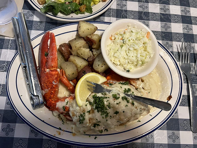 This isn't just dinner&mdash;it's edible architecture. Tender lobster meat, potatoes, and coleslaw creating the holy trinity of seafood satisfaction.