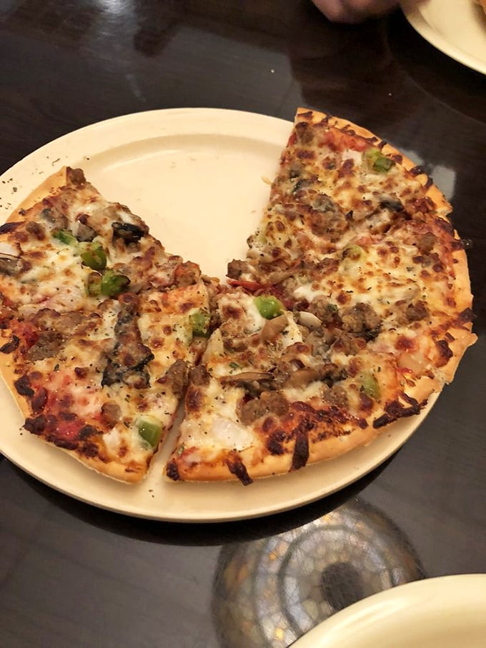 The Supreme pizza arrives like a flavor convention where every topping has something important to contribute to the conversation.