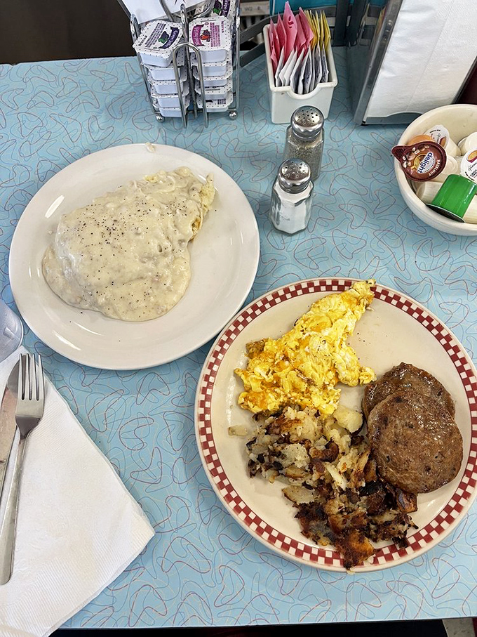 Morning perfection on a plate &ndash; golden hash browns, fluffy scrambled eggs, and a sausage patty that would make your cardiologist wince and your soul sing.
