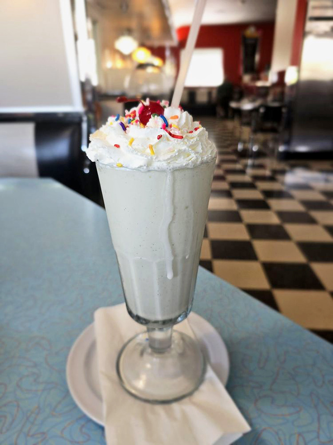 A vanilla milkshake that stands tall and proud, crowned with a mountain of whipped cream and rainbow sprinkles&mdash;childhood in a glass. 