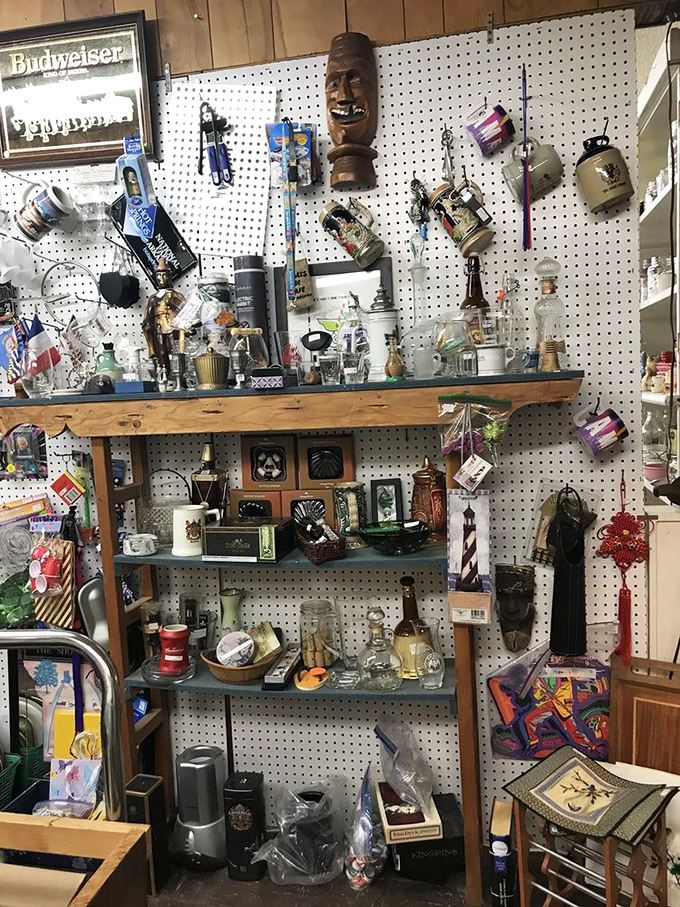 Wall-to-wall wonders! A wooden tiki mask presides over this eclectic shrine to collectibles, where Budweiser memorabilia meets decorative bottles.