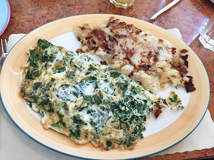 This veggie omelet isn't just healthy eating—it's a garden party wrapped in perfectly cooked eggs, with home fries that could make a potato farmer weep with joy.