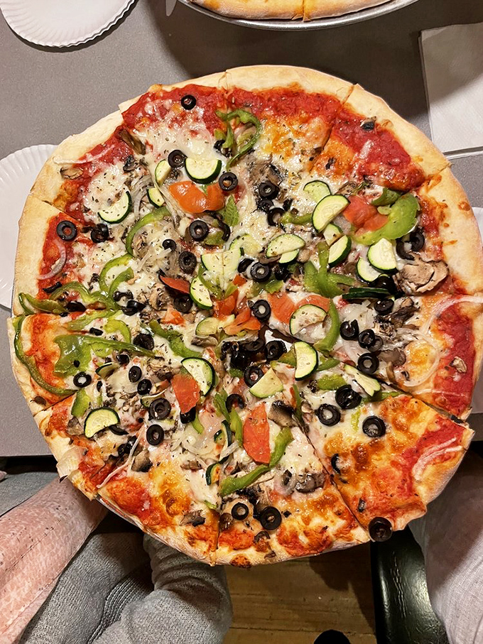 A veggie pizza masterpiece that makes you question your carnivorous ways. Every colorful topping arranged with such care, it's practically a garden party on dough.