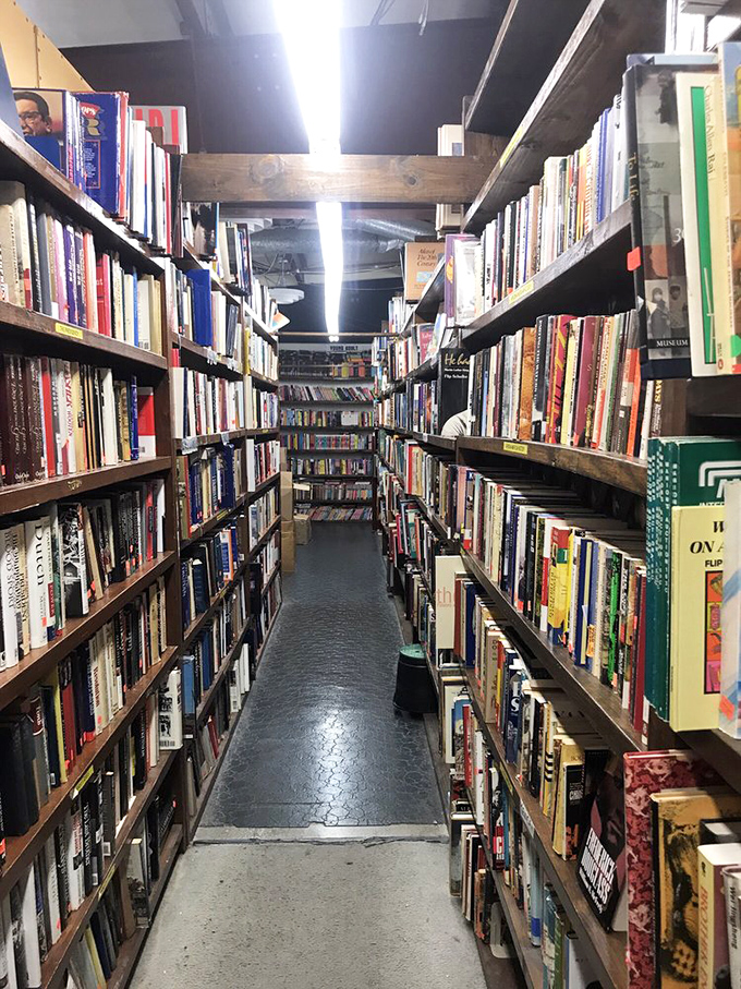 Down the rabbit hole you go! These narrow pathways between towering shelves feel like secret passages to literary dimensions.