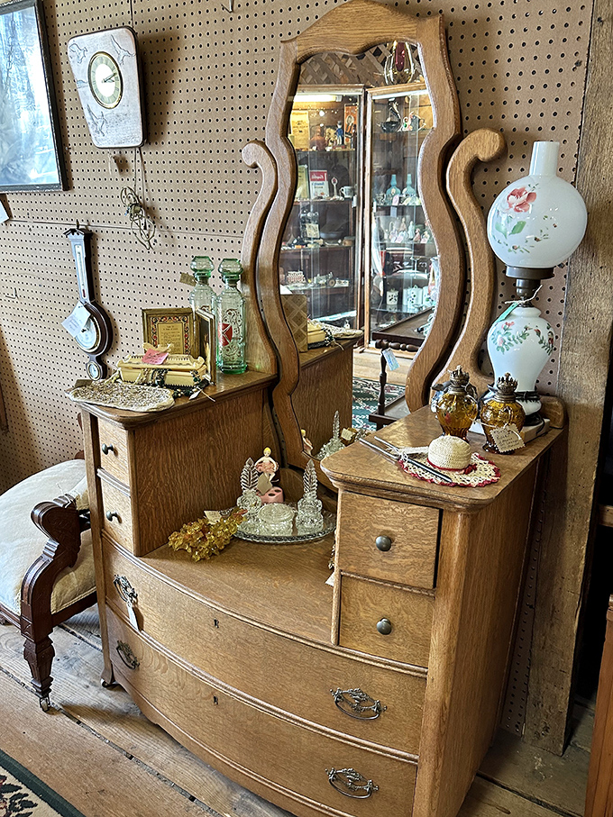 This tiger oak dresser has witnessed more morning routines than a barista. That curved mirror has reflected a century of faces wondering, "How do I look?"