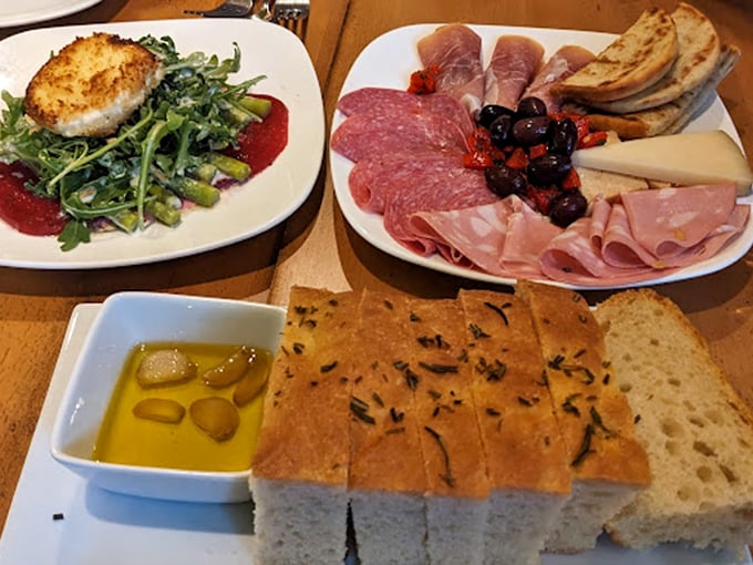 The antipasto board that launched a thousand conversations—cured meats, artisanal cheeses, and that olive oil you'll be tempted to drink straight from the dish.