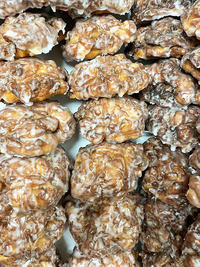 These apple fritters aren't just pastries, they're topographical masterpieces &ndash; craggy peaks of cinnamon-spiced dough glazed to glistening perfection.