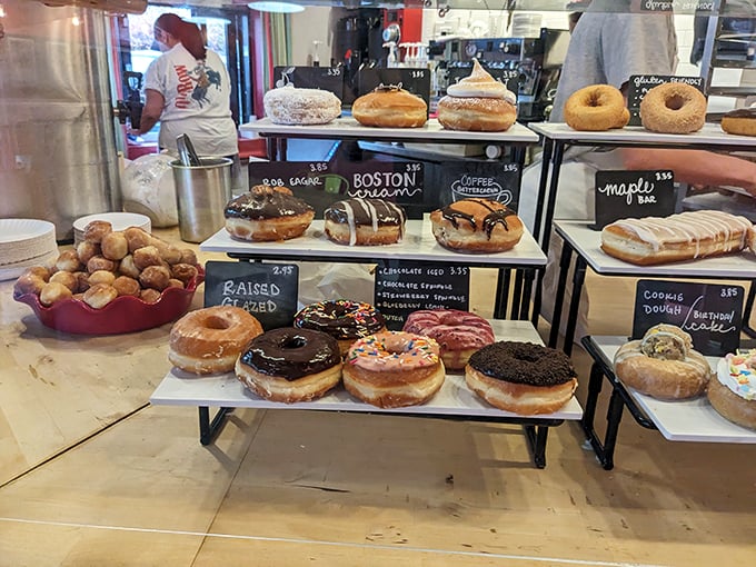 Donut display cases: where dreams are stacked three tiers high and willpower goes to die. Each one a masterpiece of sugar architecture.