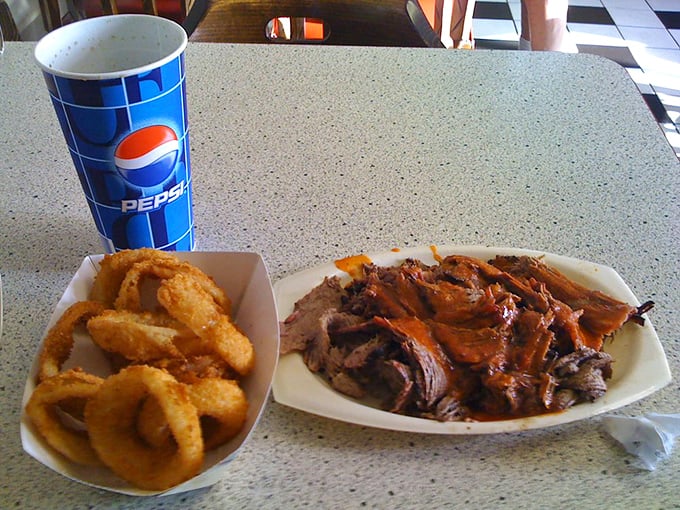 Crispy golden onion rings provide the perfect textural contrast to the tender, smoke-kissed brisket that melts faster than your willpower.