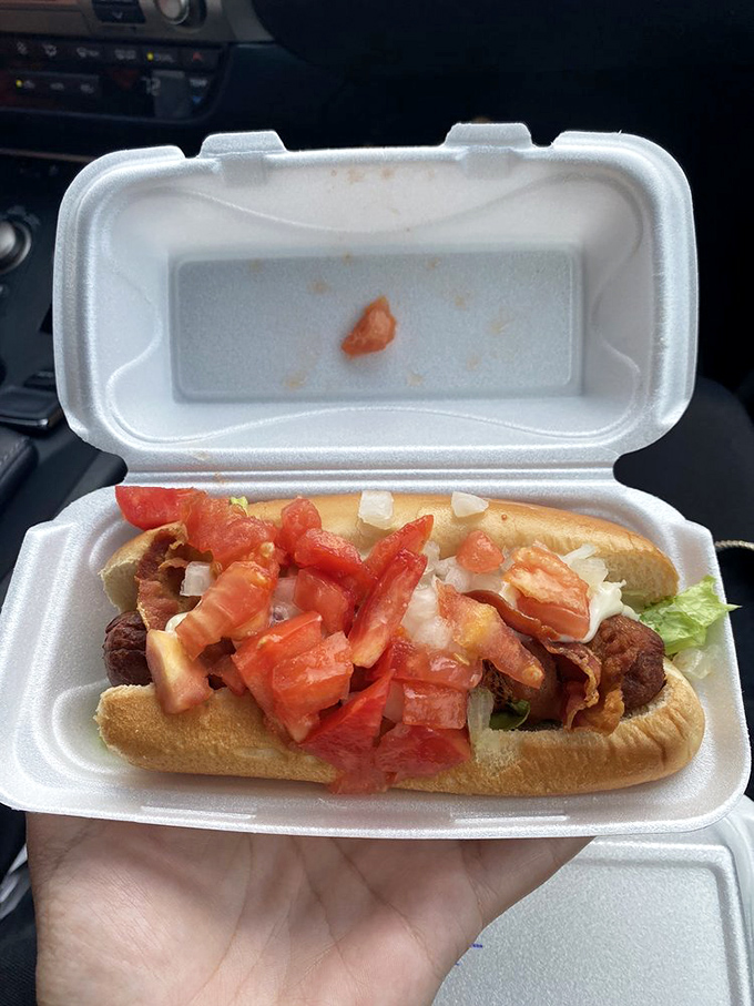 This BLT dog isn't merely topped—it's architecturally sound, a skyscraper of fresh tomatoes and crisp bacon demanding both hands and several napkins.