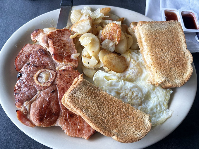 Breakfast perfection doesn't need fancy plating&mdash;just perfectly cooked eggs, home fries with crispy edges, and ham that means business.