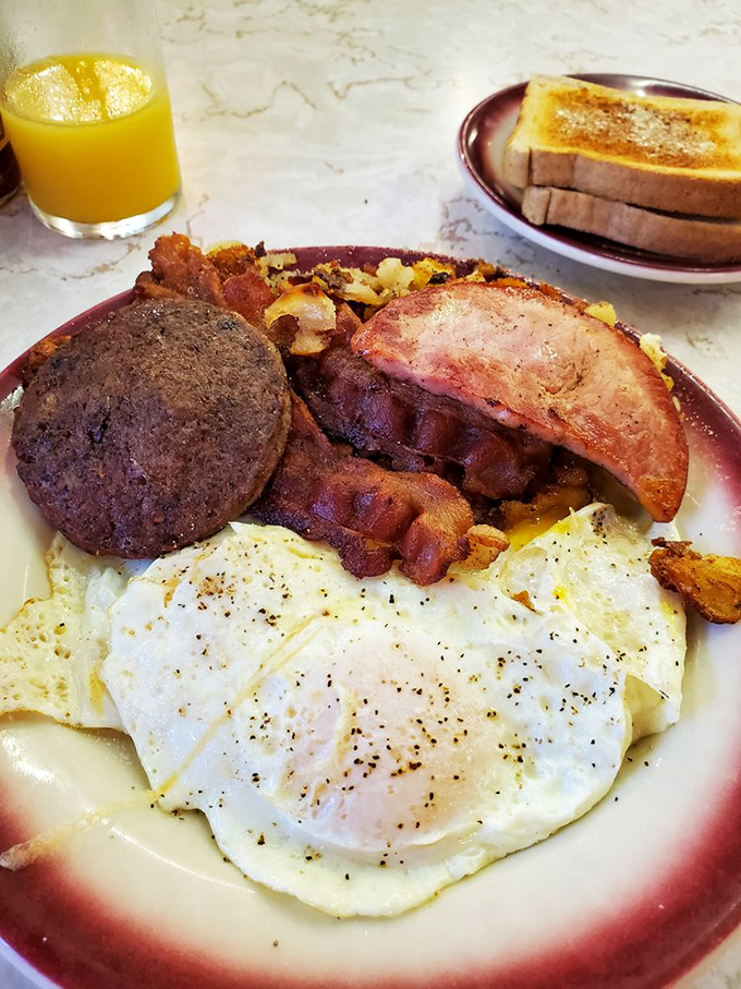 Breakfast alchemy at its finest: perfectly cooked eggs, crispy bacon, and that mysterious Mid-Atlantic delicacy called scrapple that confounds outsiders but delights locals.
