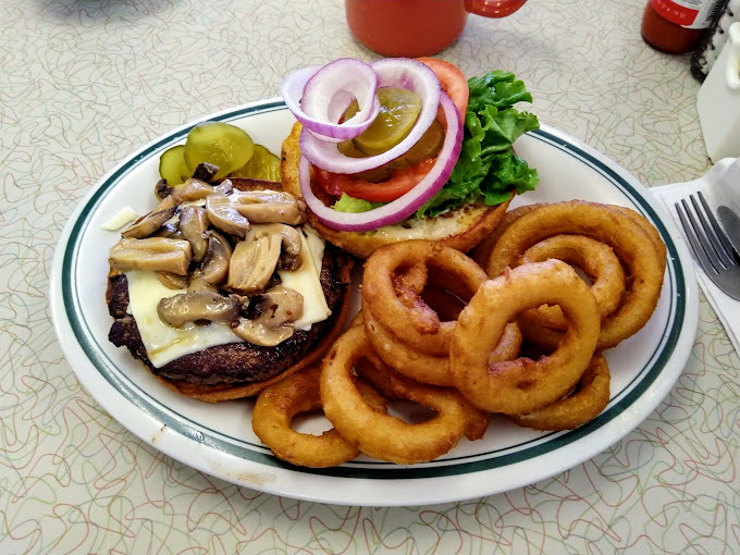 This isn't just a burger—it's a masterclass in diner perfection, complete with mushrooms, cheese, and onion rings that deserve their own fan club.