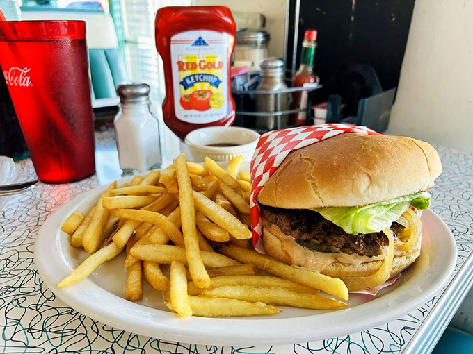 Not all heroes wear capes; some come on a white plate with golden fries and a pickle spear standing guard.