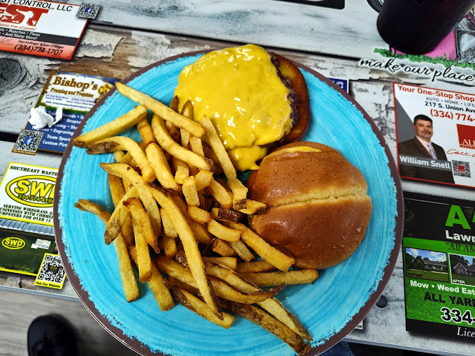 This cheeseburger isn't just wearing cheese—it's draped in a golden blanket of it, like it's ready for a nap after you devour it.